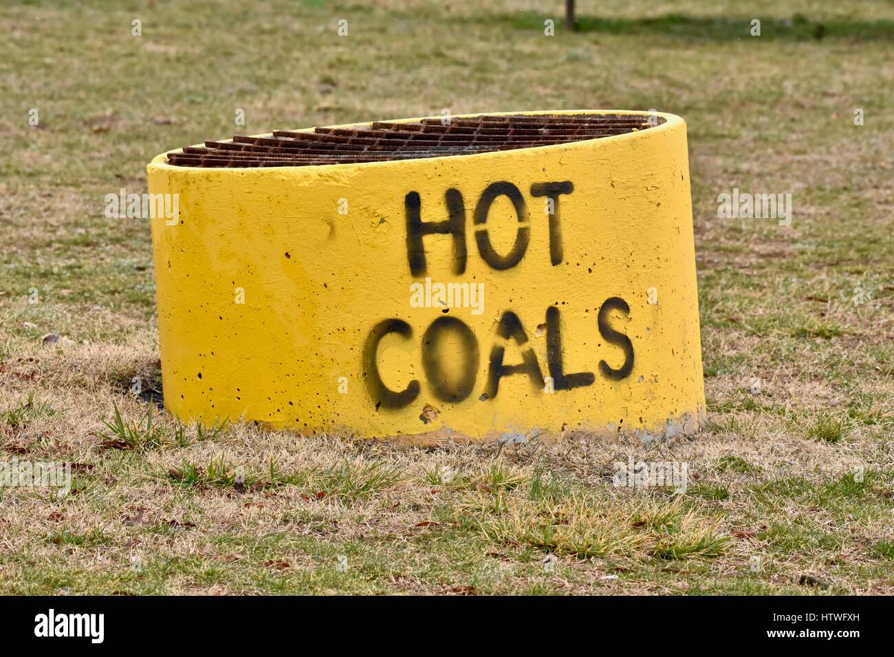 Campground fire pit with hot coals warning Stock Photo - Alamy