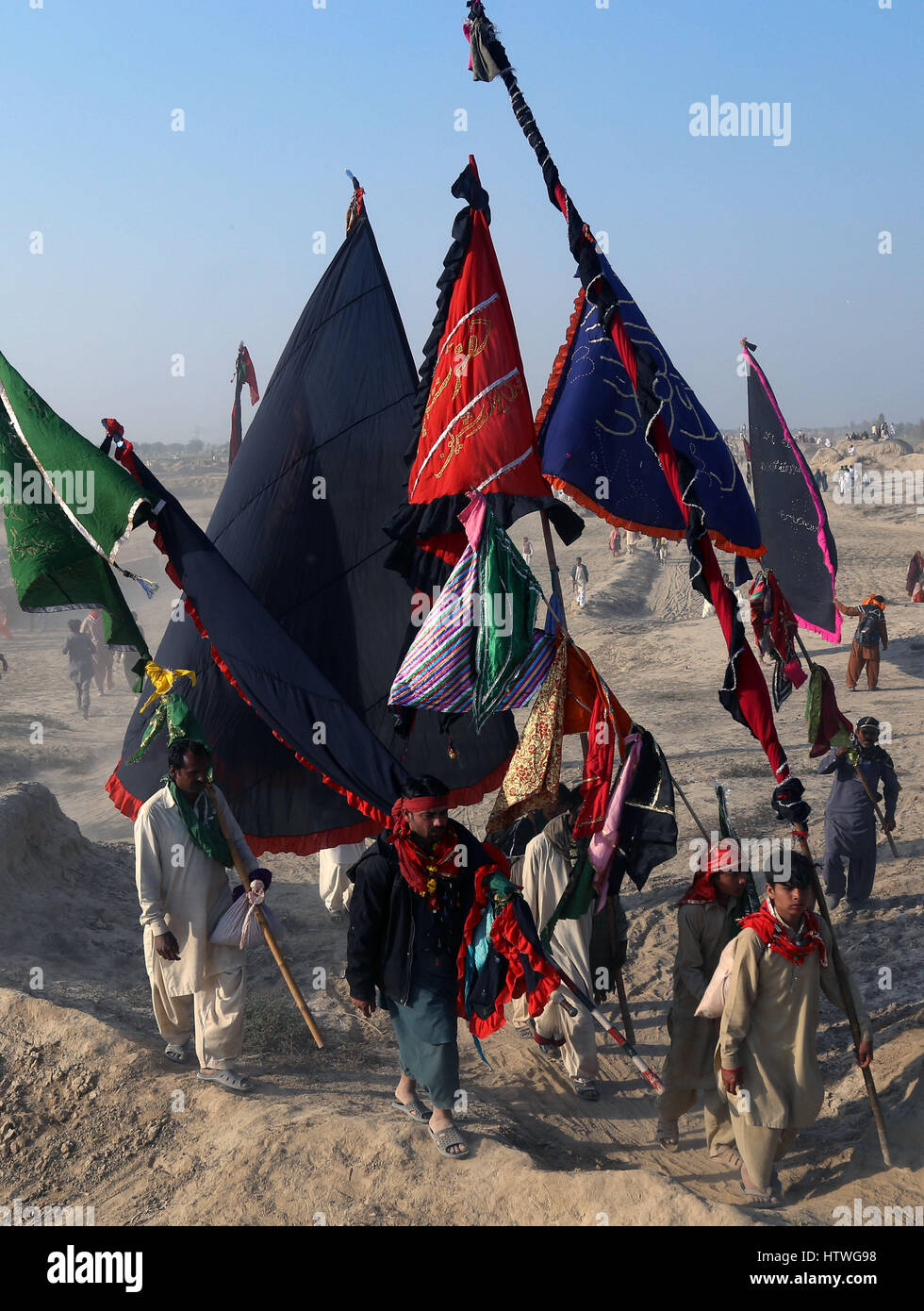 Hindu devotees carrying flags on their journey to the shrine of the ...