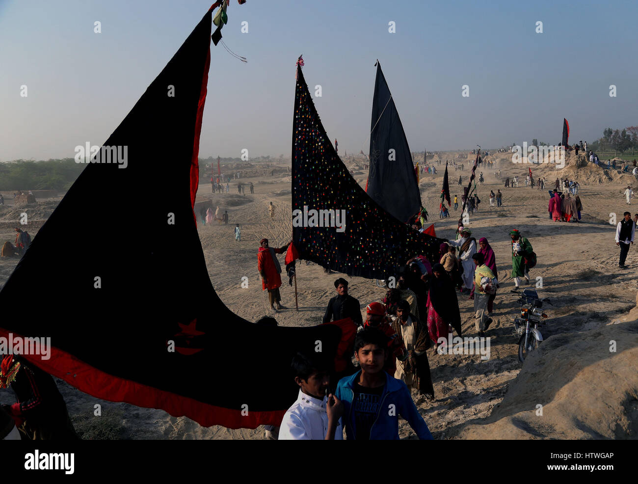 Hindu devotees carrying flags on their journey to the shrine of the ...