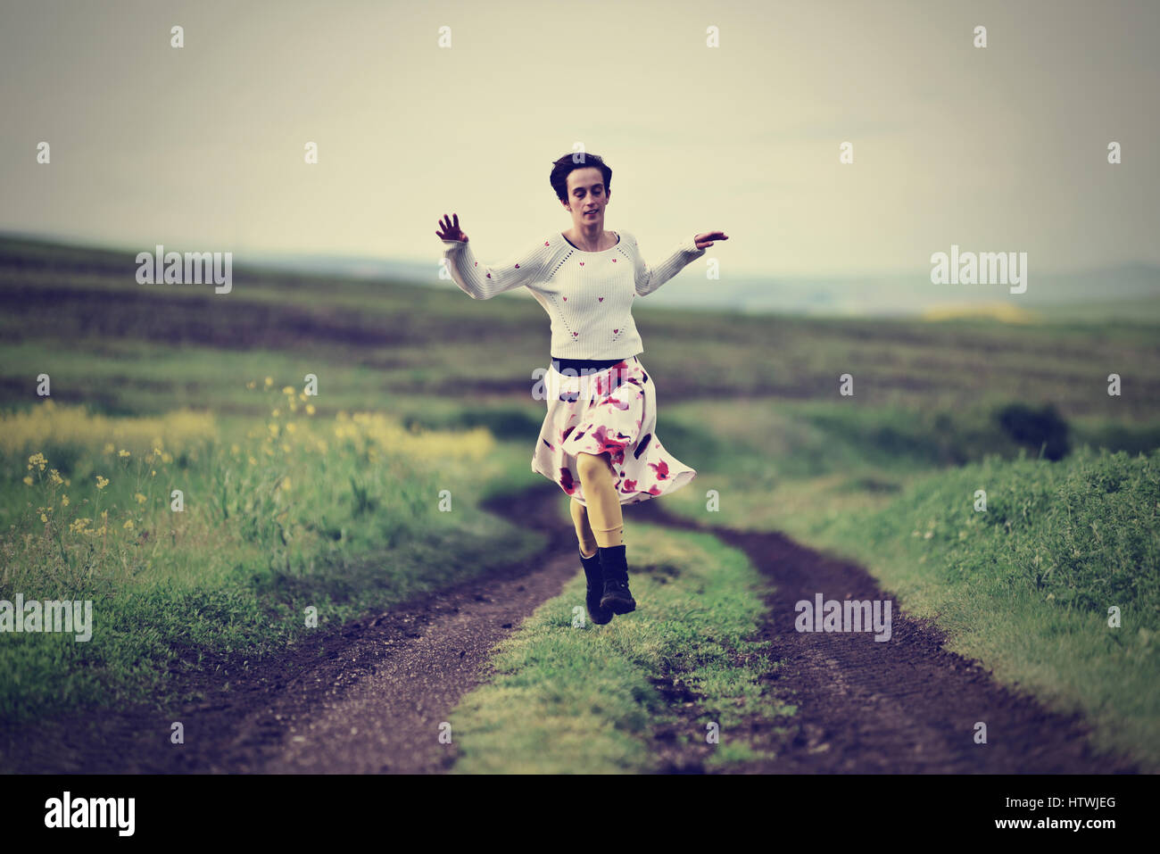 Vintage woman running on a countryside road. Freedom concept Stock ...