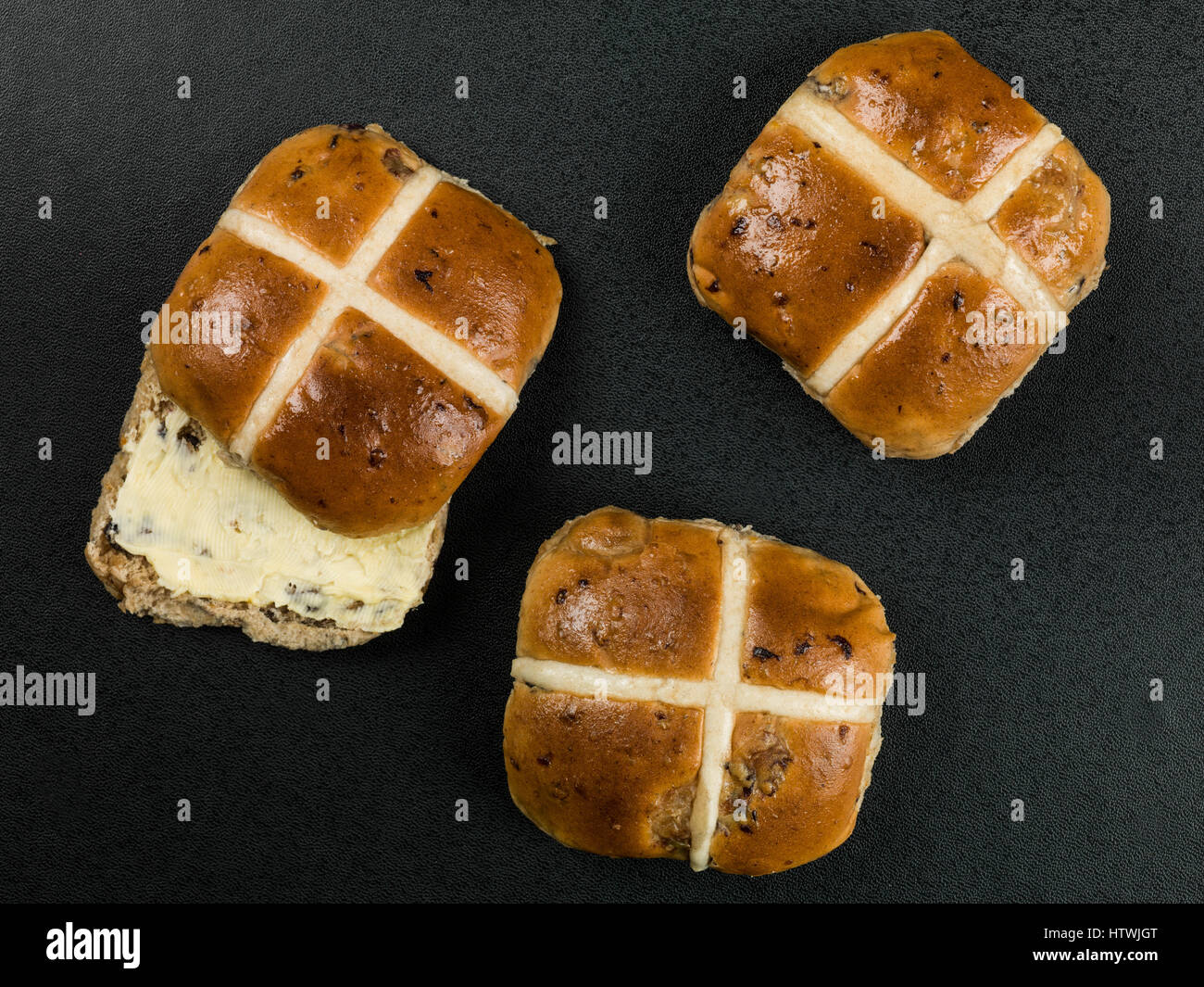 Three Hot Cross Buns Against a Black Background Stock Photo - Alamy