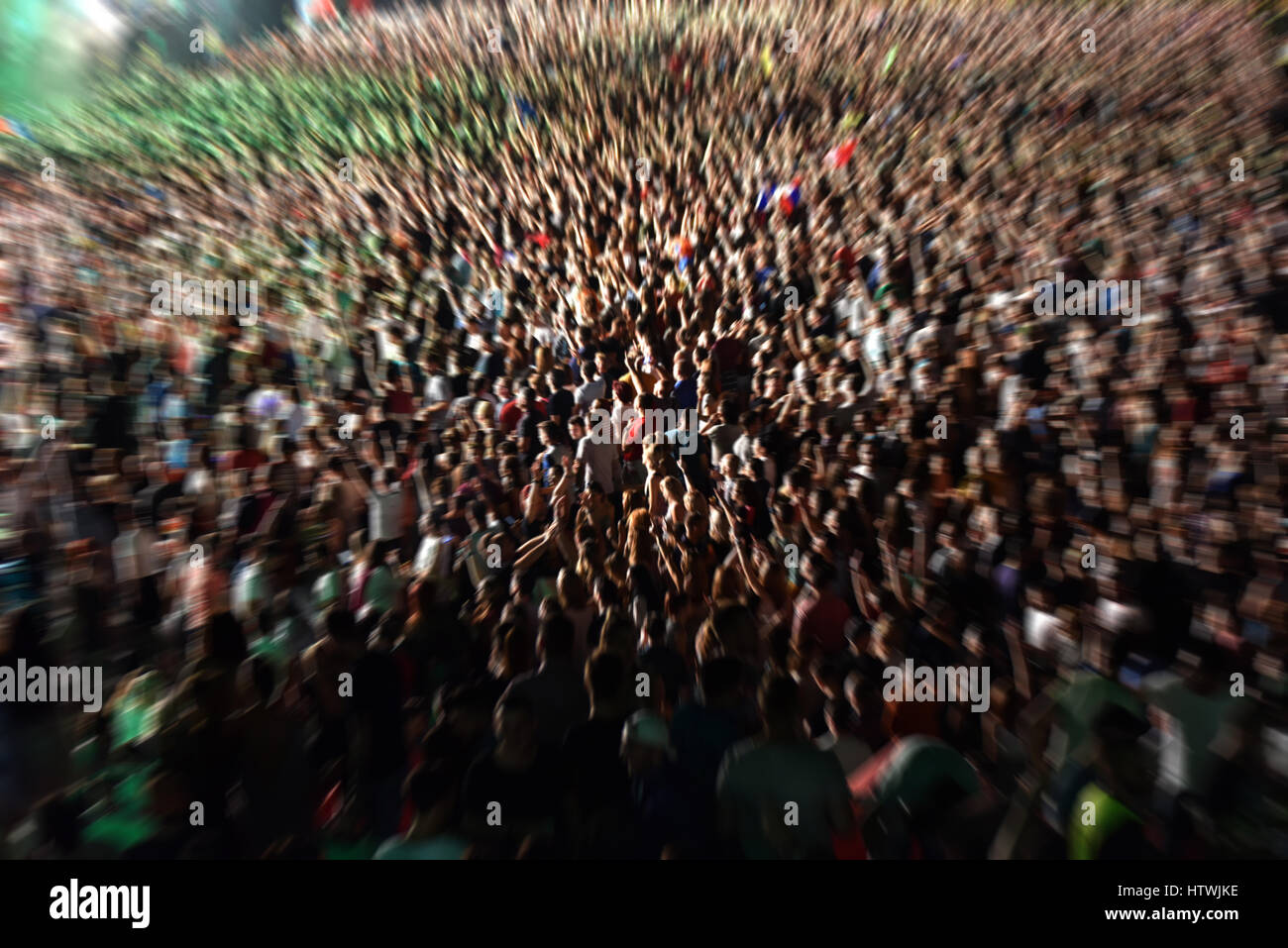 Zoom in effect on a blurred crowd partying at a music festival Stock ...