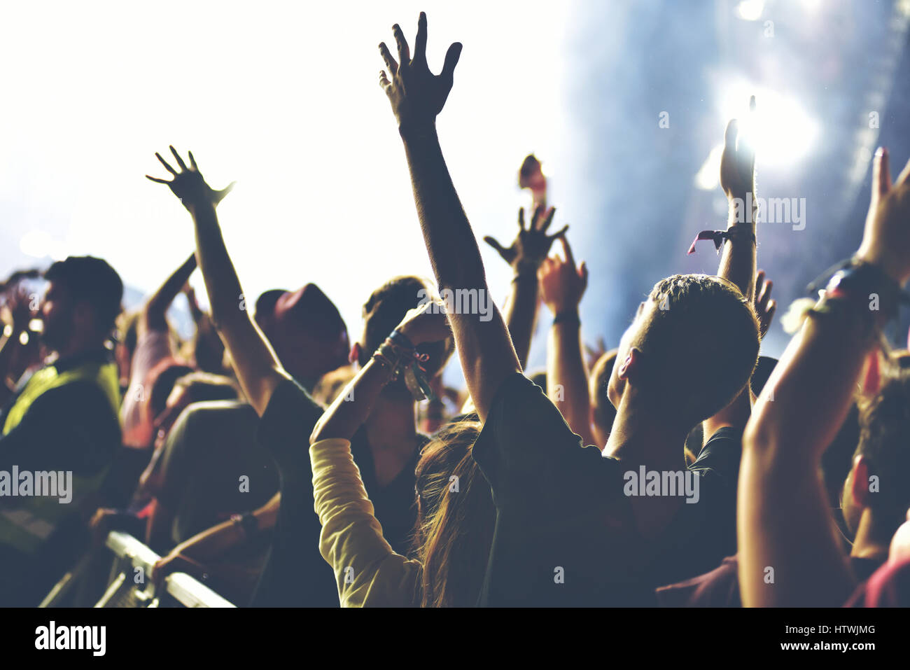 Rear view of crowd with arms outstretched at concert Stock Photo - Alamy