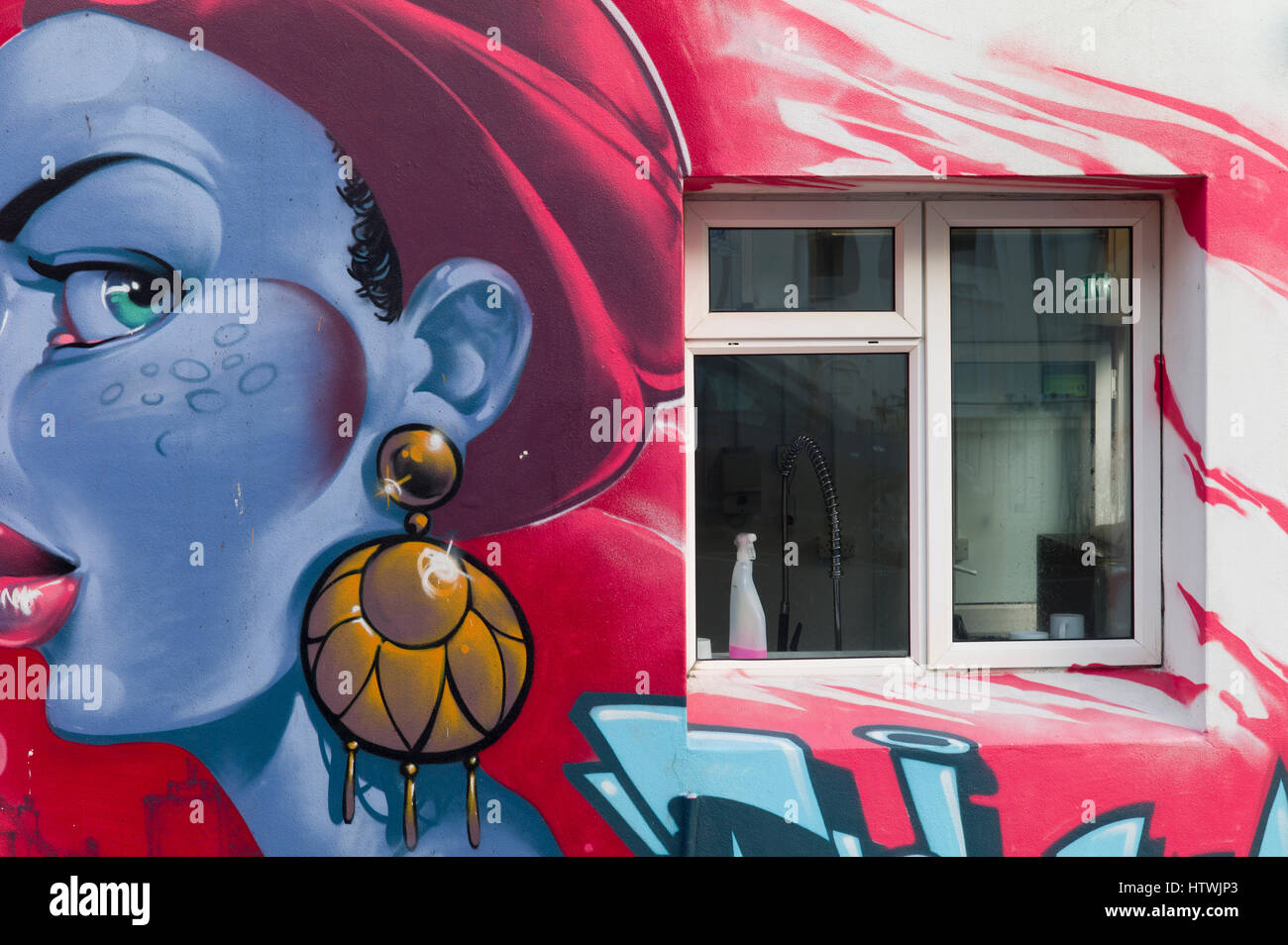 Graffiti of woman's profile on wall with window Stock Photo - Alamy