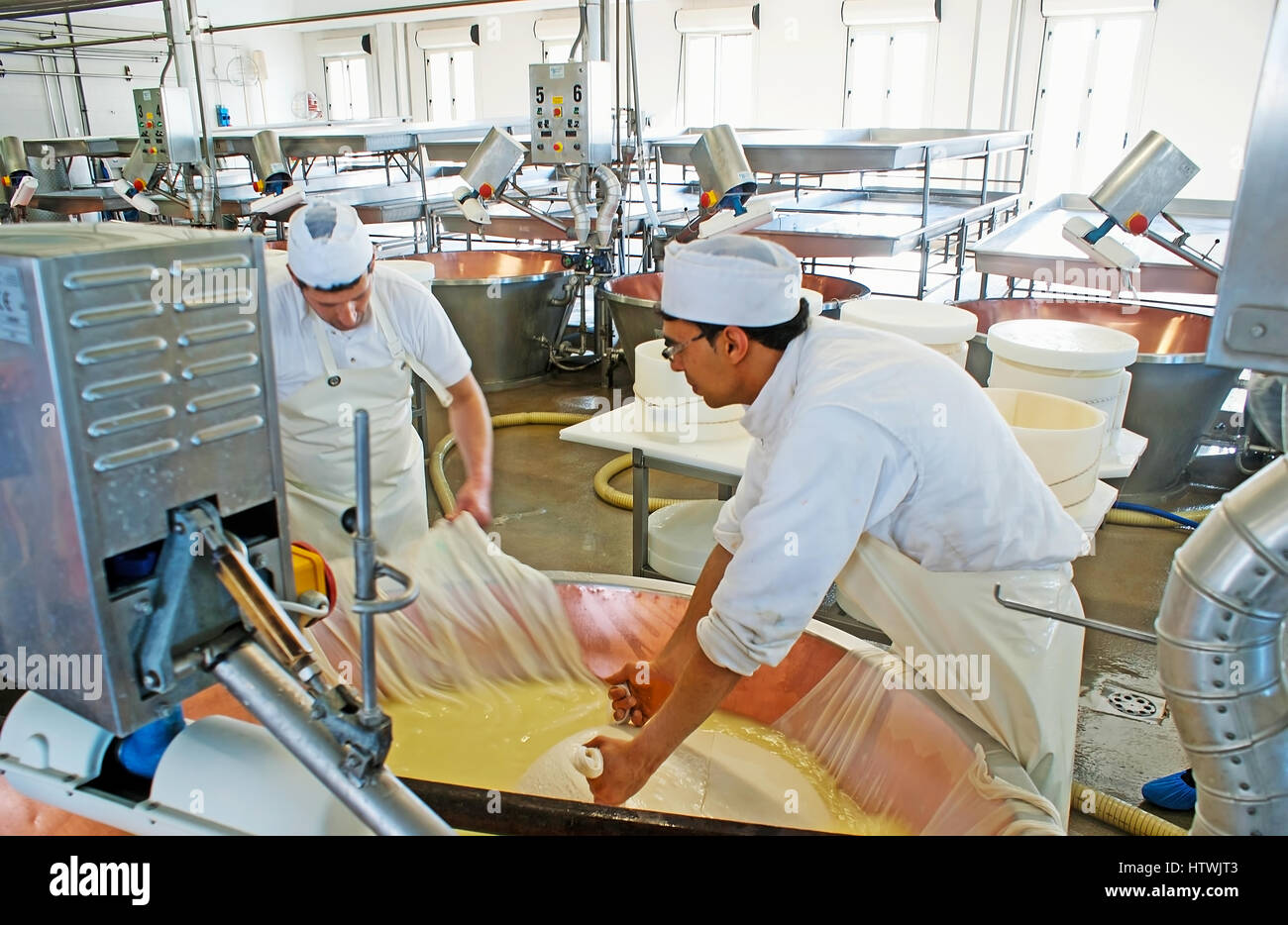 PARMA, ITALY - APRIL 24, 2012: The processing of famous parmigiano ...