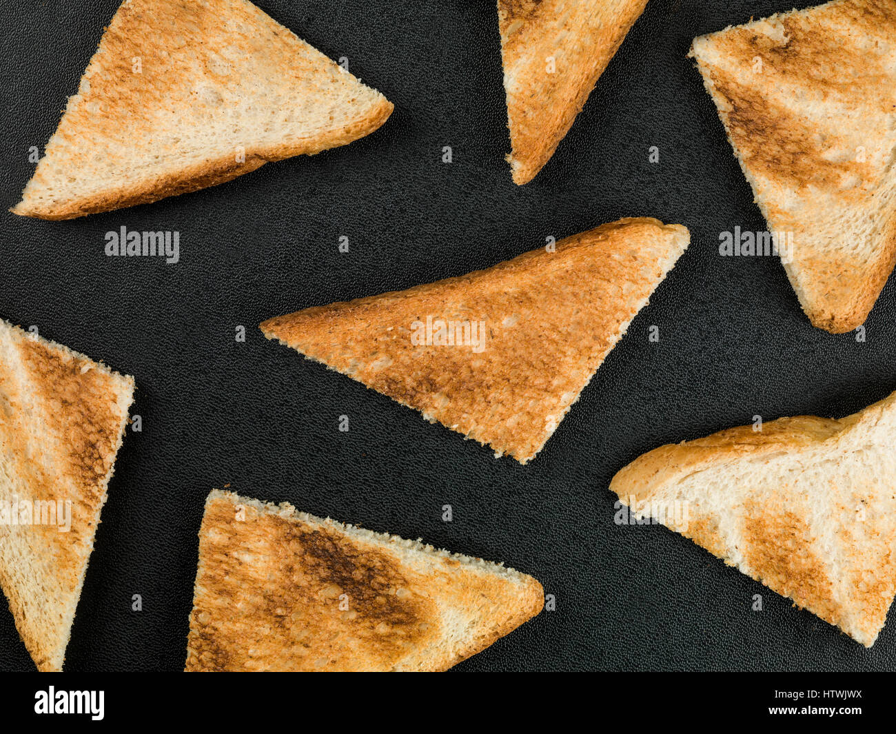 Pattern of Toasted Bread Triangles Against a Black Background Stock ...