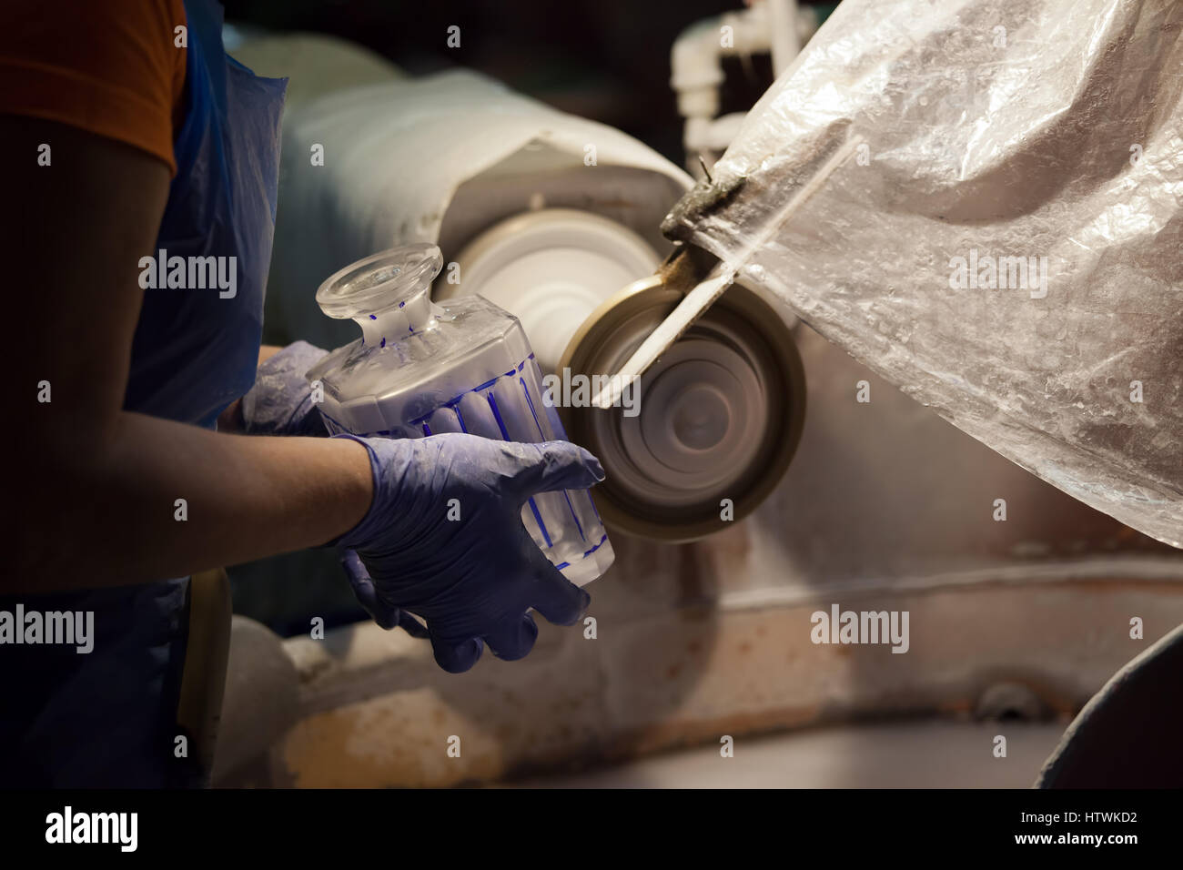 Glassmaker worker polishing crystal lead glass Stock Photo - Alamy