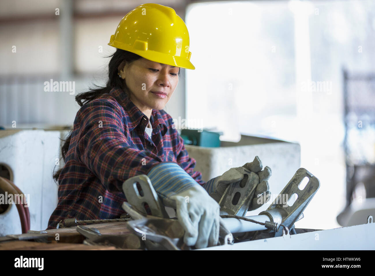 Female power engineer putting equipment into bucket truck Stock Photo ...