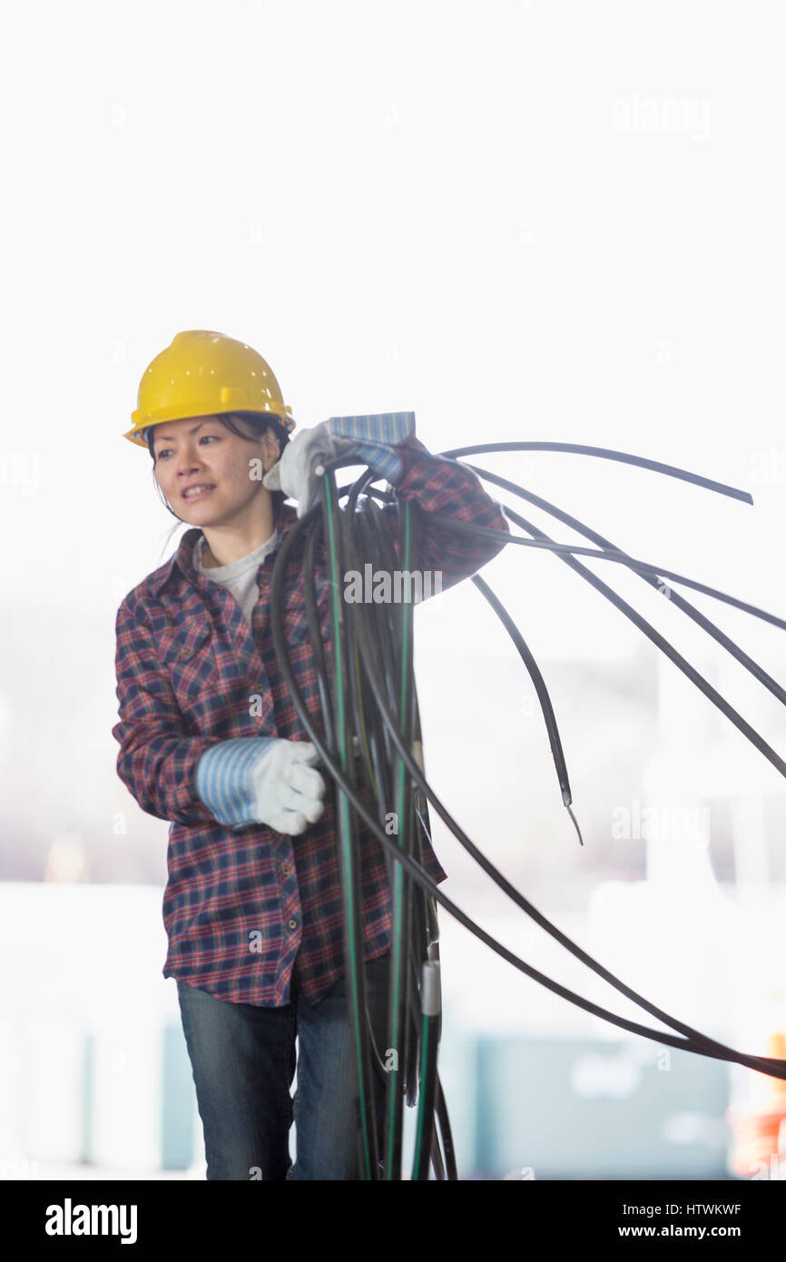 Female power engineer with power cable Stock Photo - Alamy
