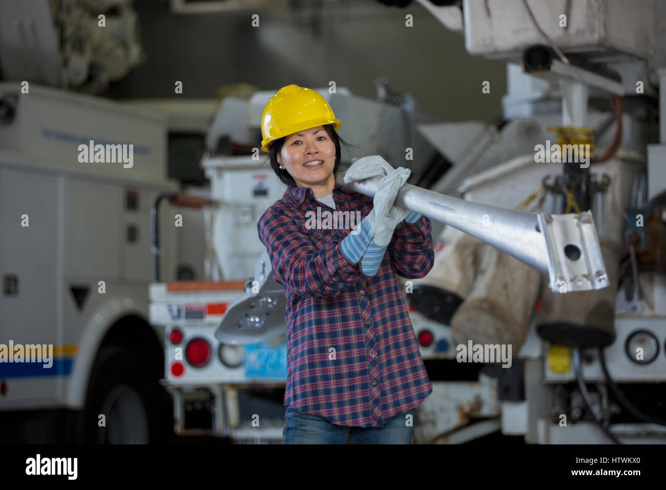 Female power engineer moving a street lamp in service garage Stock ...