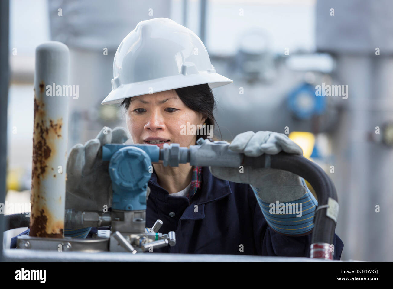 Female power engineer checking transducer at power station Stock Photo ...