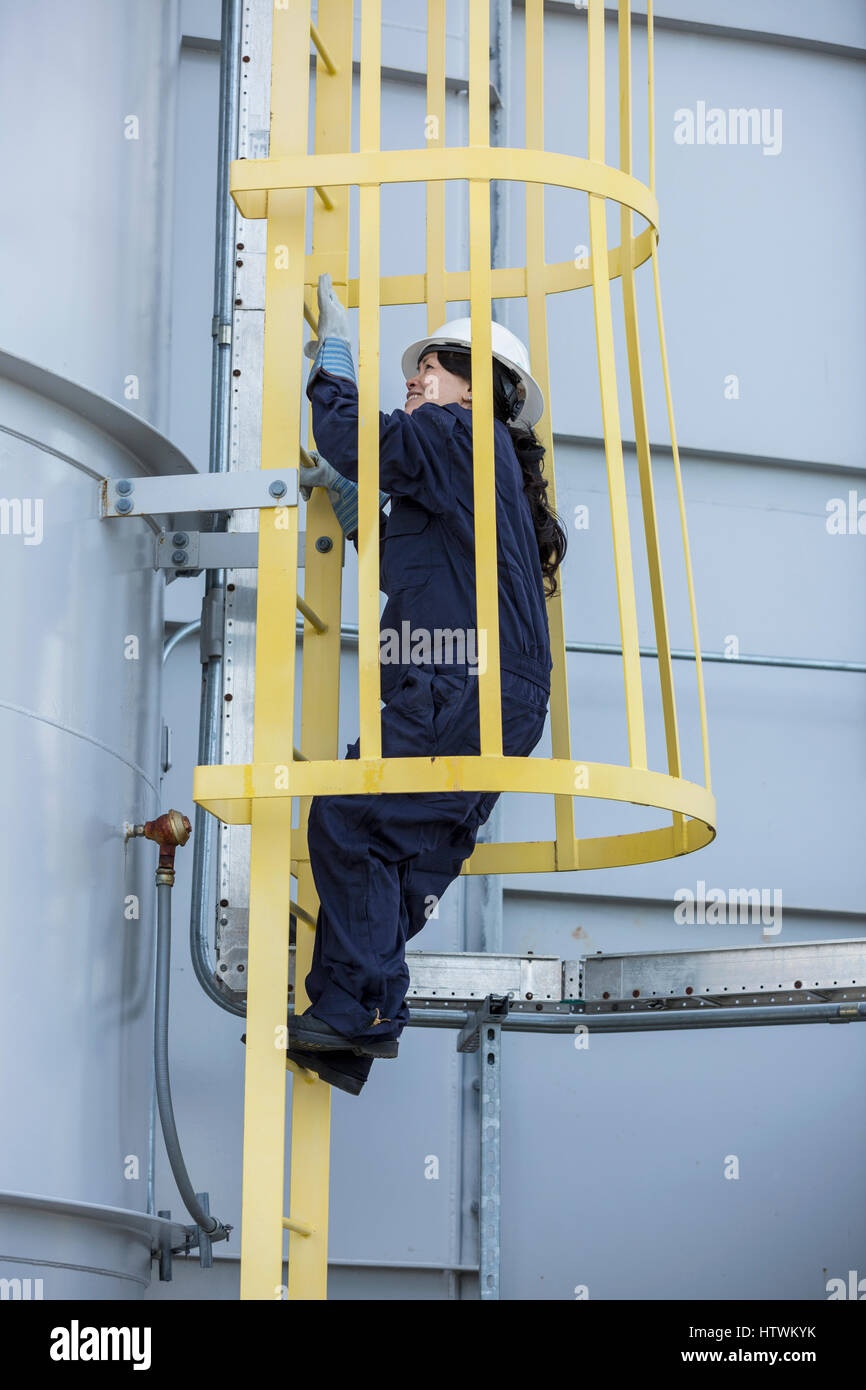 Woman climbing ladder hi-res stock photography and images - Alamy