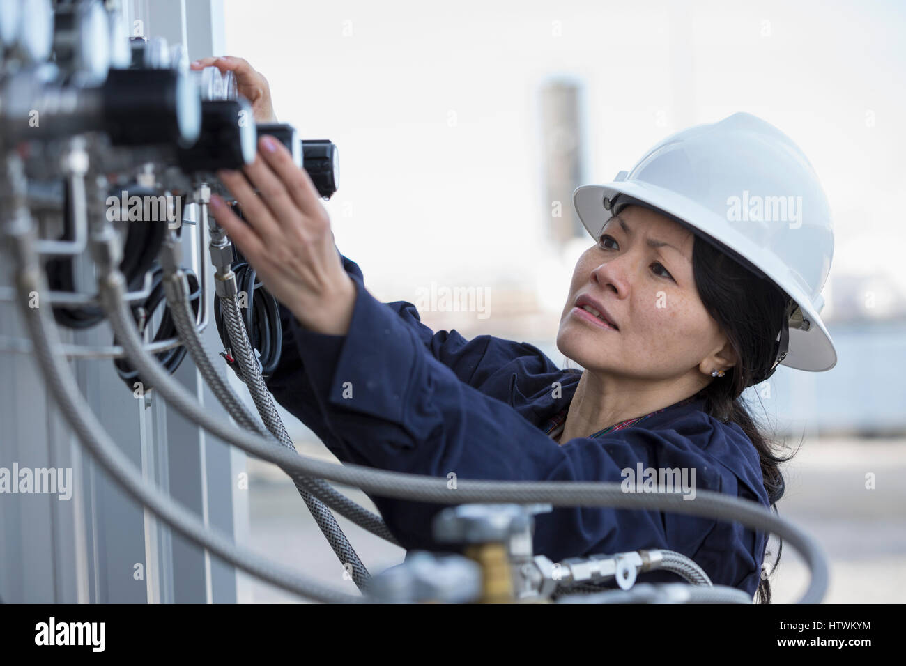 Female power engineer checking transducer at power station Stock Photo ...