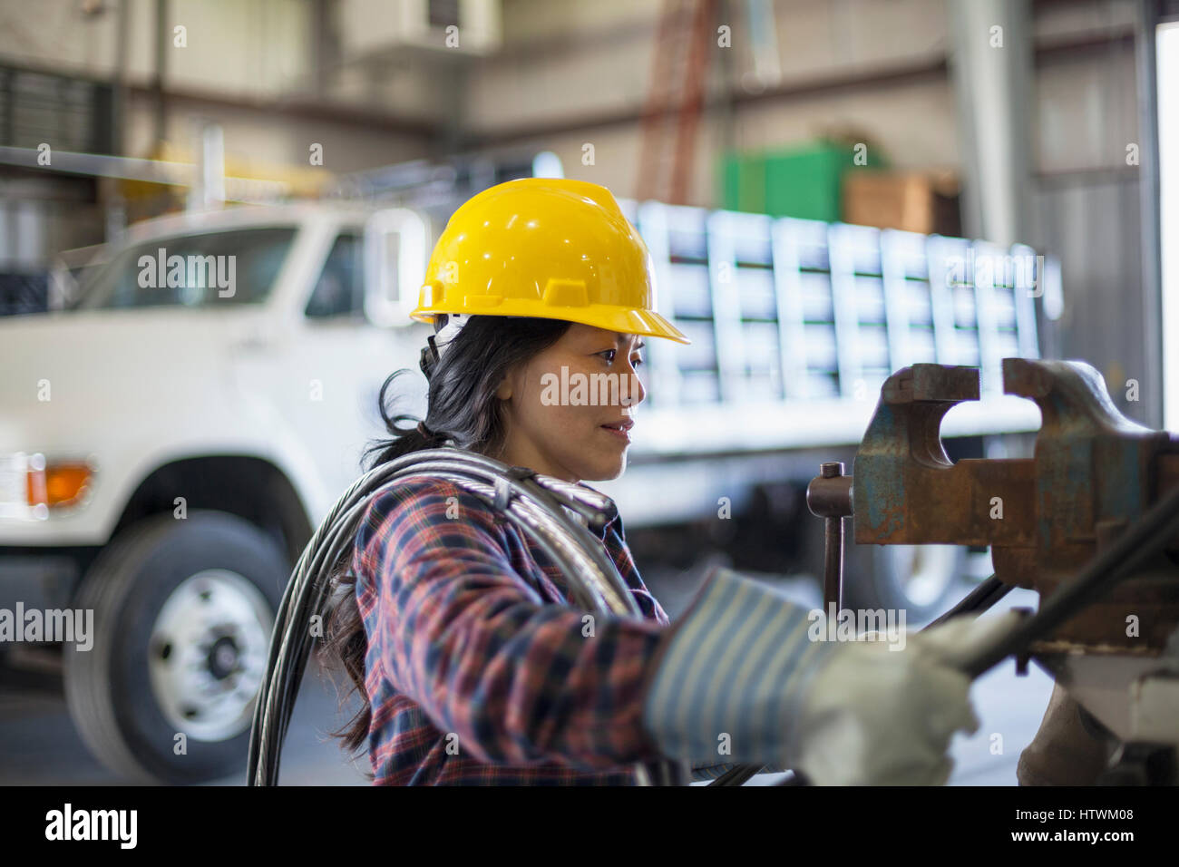Female power engineer with power cable in service garage Stock Photo ...