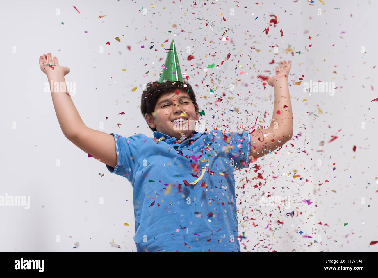 Happy kid celebrating party with blowing confetti Stock Photo - Alamy