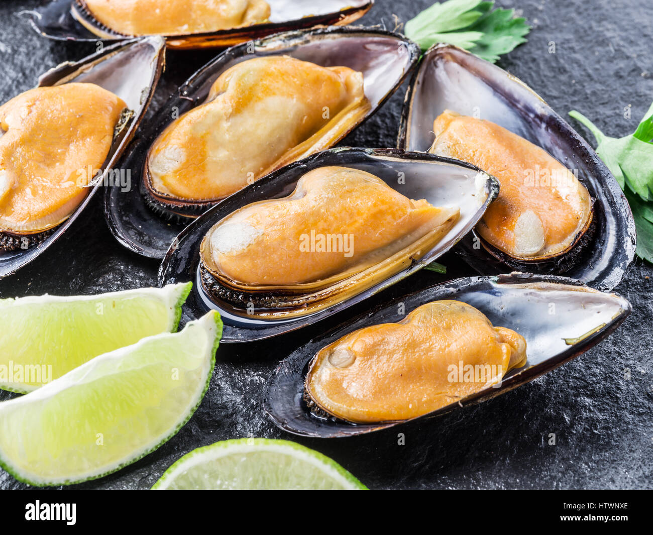 Boiled mussels on the graphite background Stock Photo - Alamy