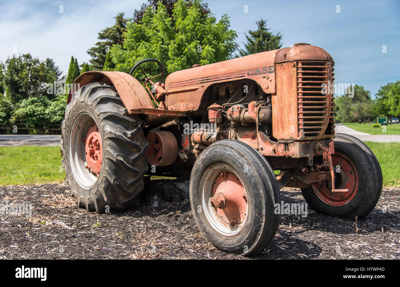 An old faded red Case tractor sits on the edge of a field Stock Photo ...