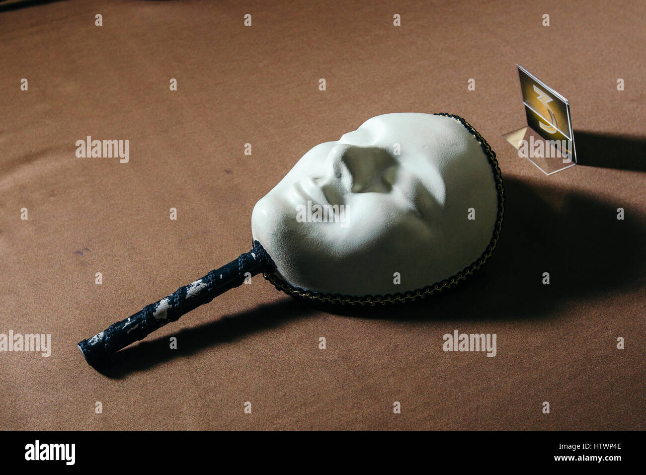 White mask for playing in the mafia on the table Stock Photo - Alamy