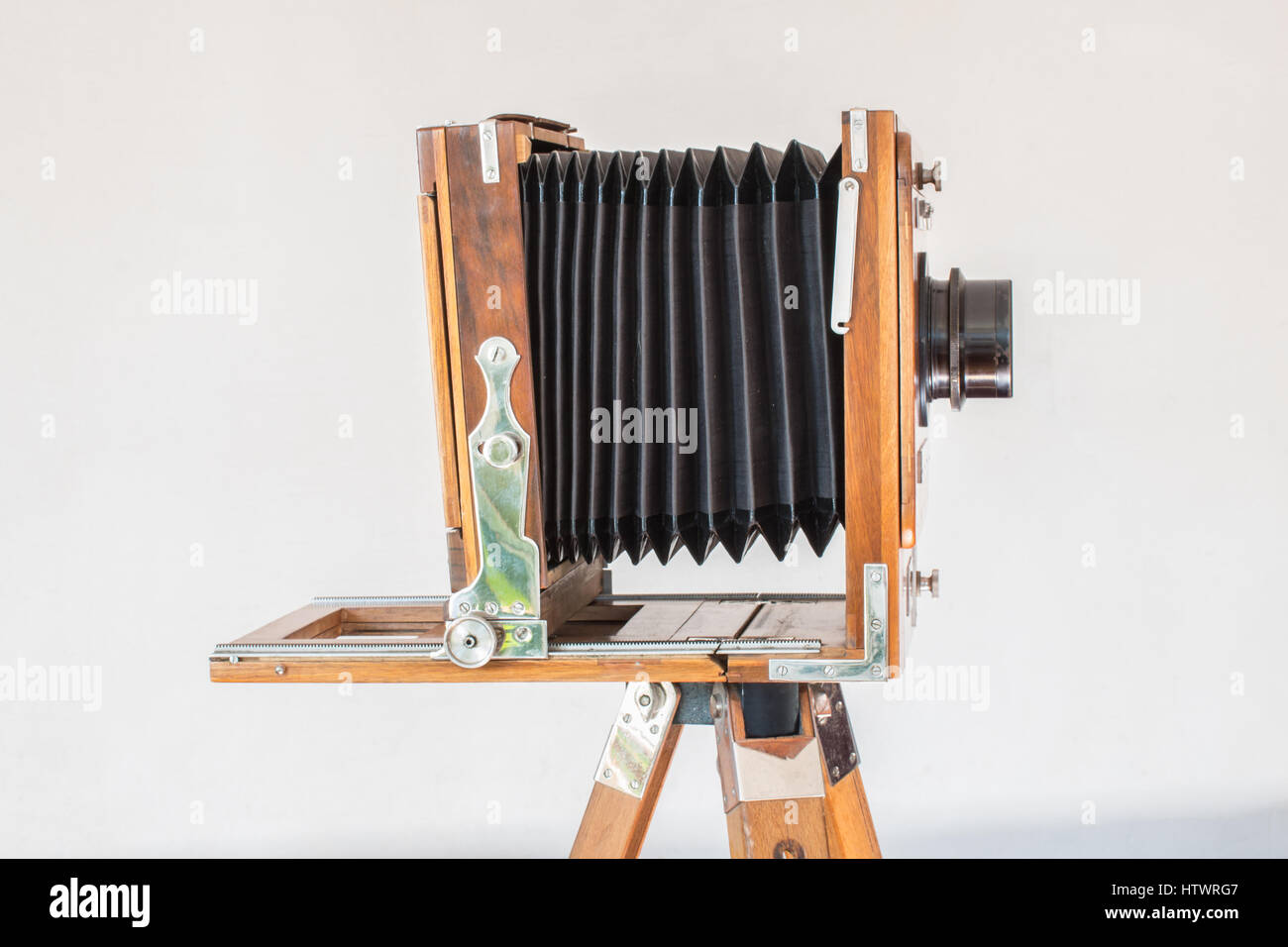 Old vintage big camera of wood and metal on white background close-up ...