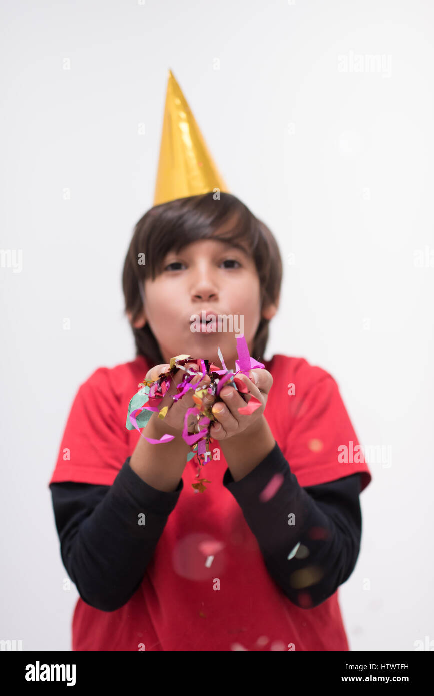 Happy kid celebrating party with blowing confetti Stock Photo - Alamy