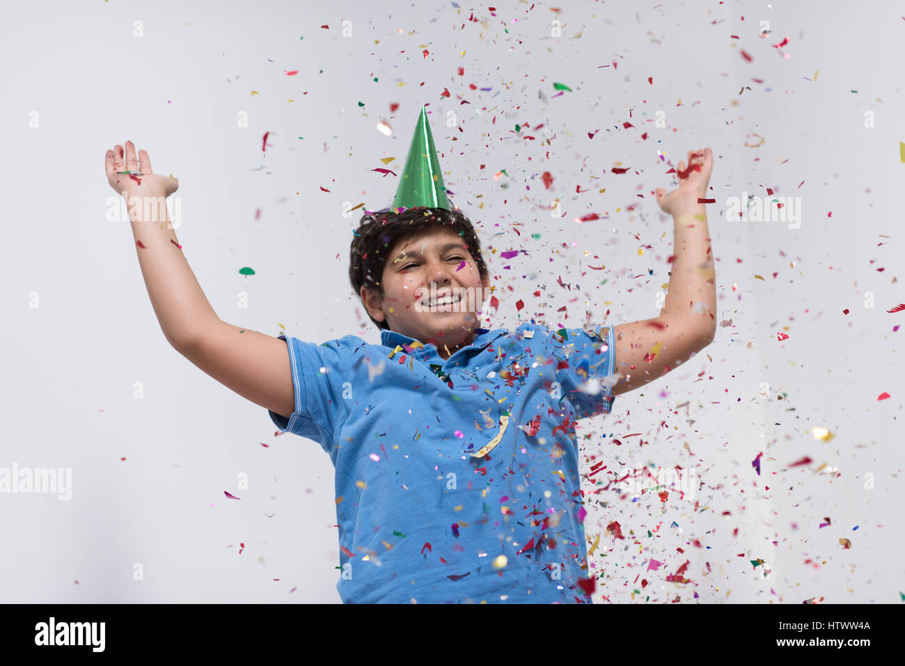 Happy kid celebrating party with blowing confetti Stock Photo - Alamy
