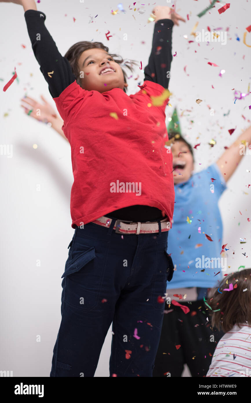 Happy kids celebrating party with blowing confetti Stock Photo - Alamy