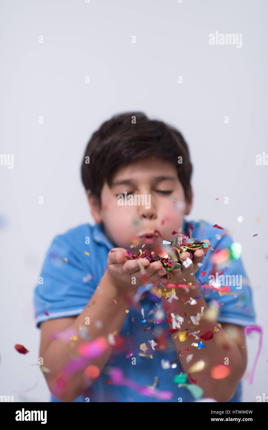 Happy kid celebrating party with blowing confetti Stock Photo - Alamy