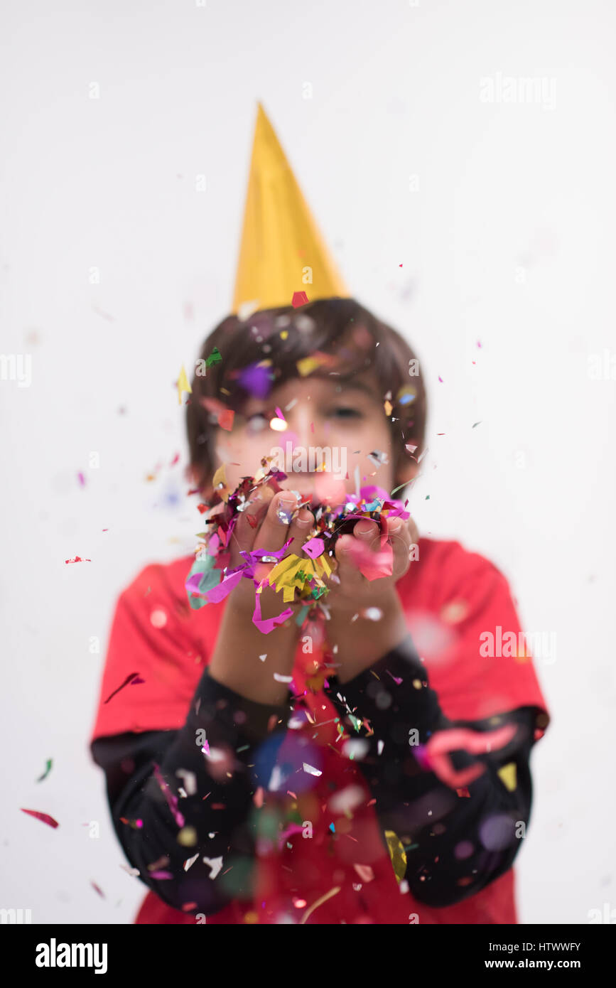 Happy kid celebrating party with blowing confetti Stock Photo - Alamy