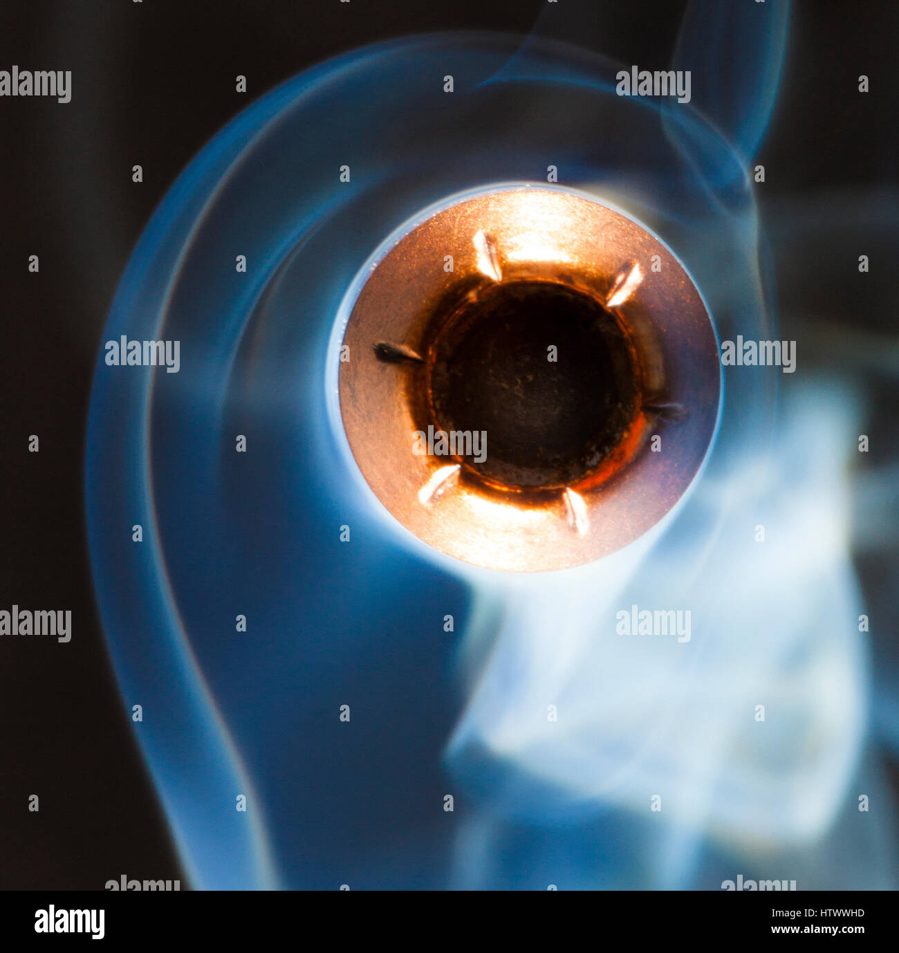 Hollow point bullet coming at the camera with circling smoke behind ...