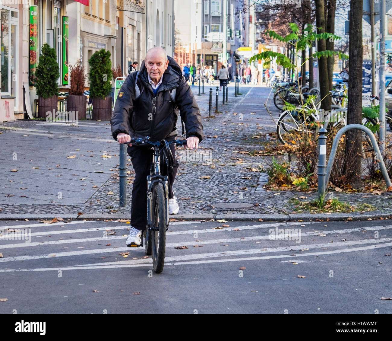 Senior male cyclist cycling in city street, urban cycling, elderly ...