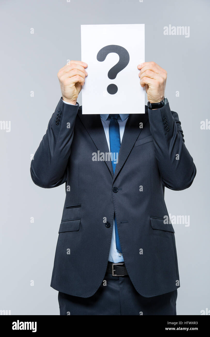 Man holding card with question mark Stock Photo - Alamy