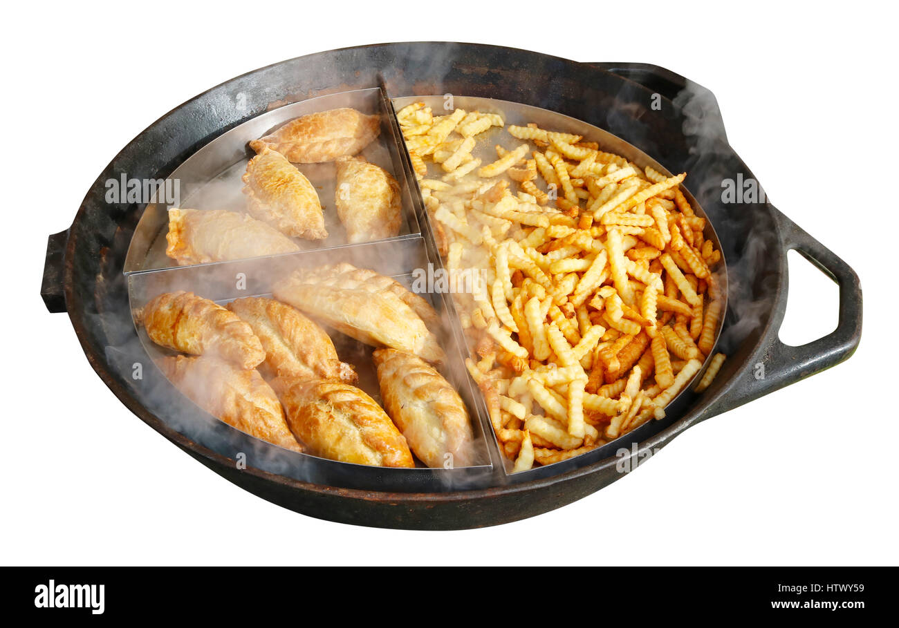 Street fast food- French fries and fried beef and chicken pies on a big ...