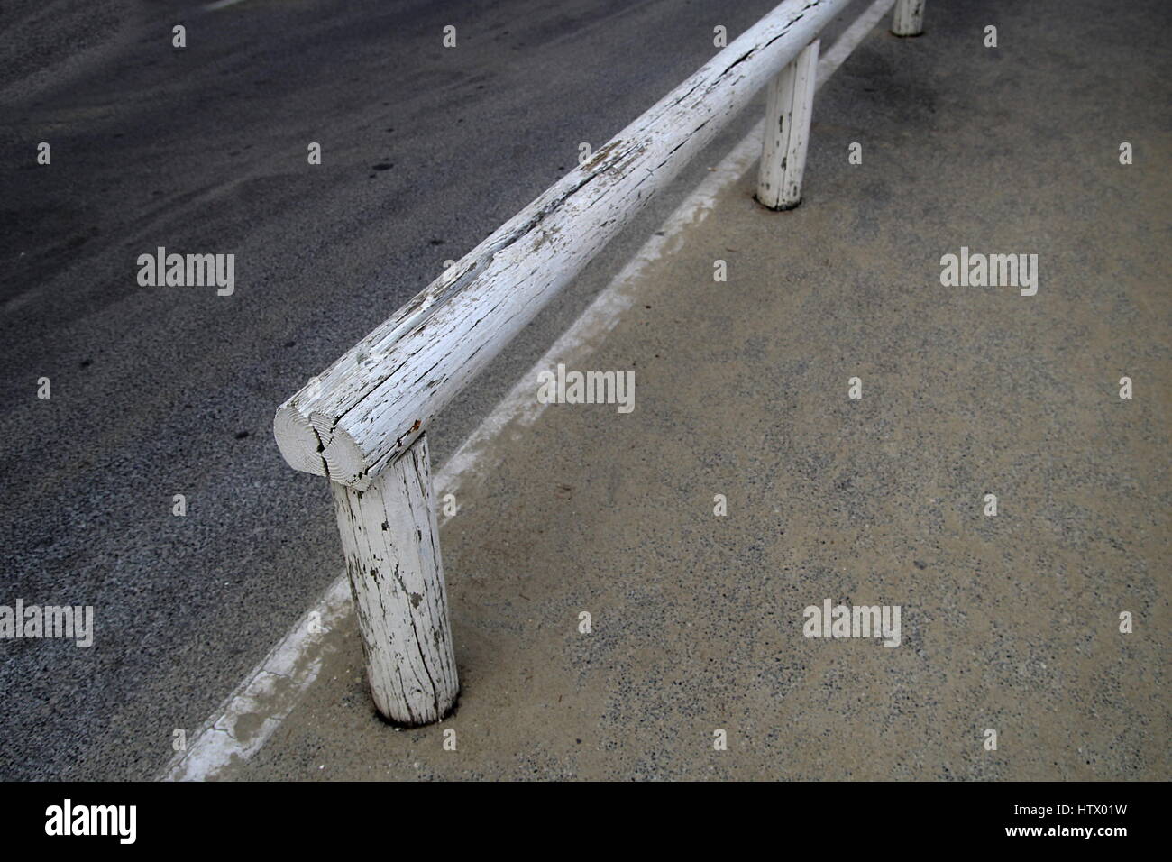 White painted wooden barrier on the roadside Stock Photo - Alamy