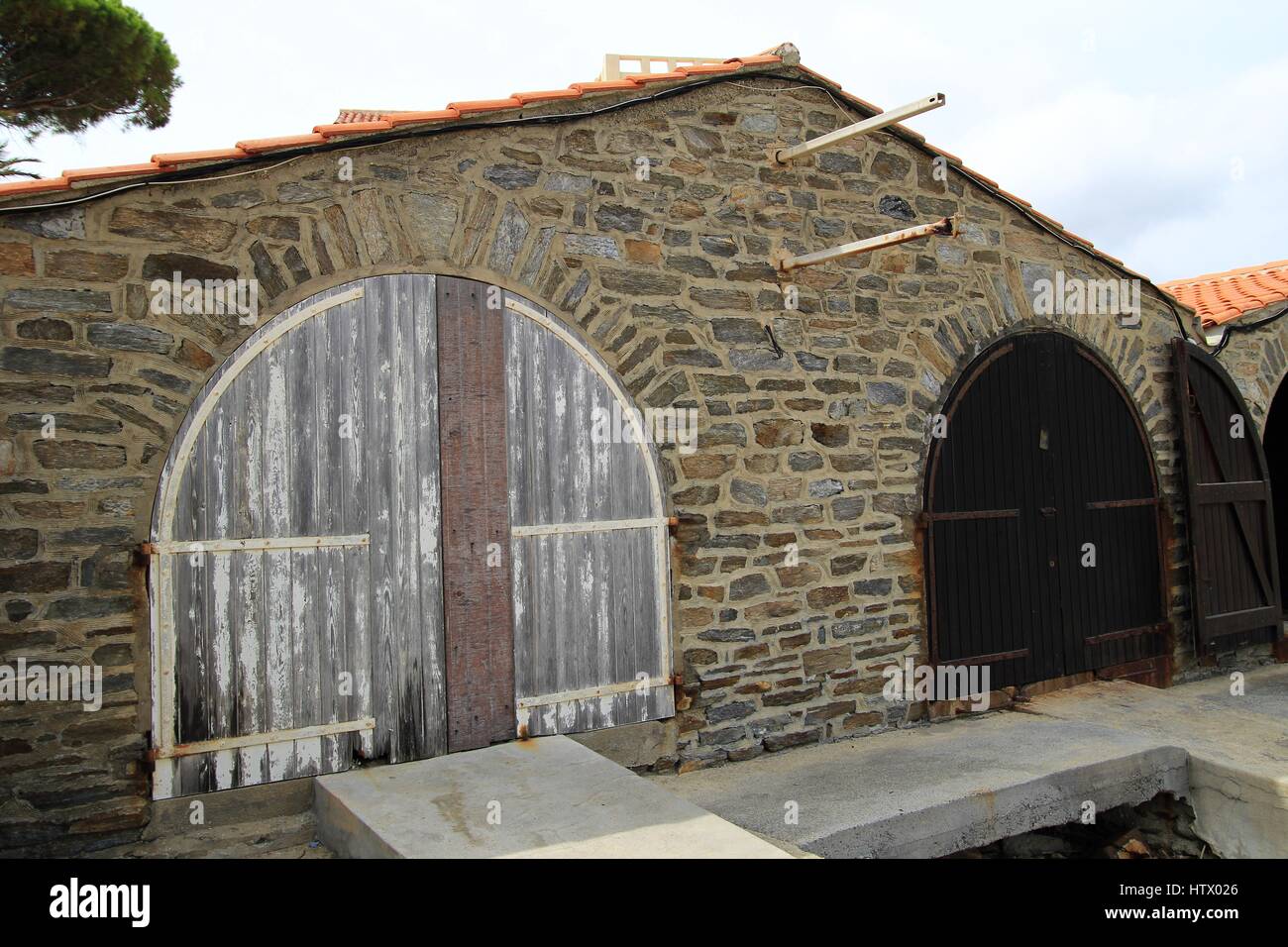 Rustic old provencal boat house with wooden doors Stock Photo - Alamy