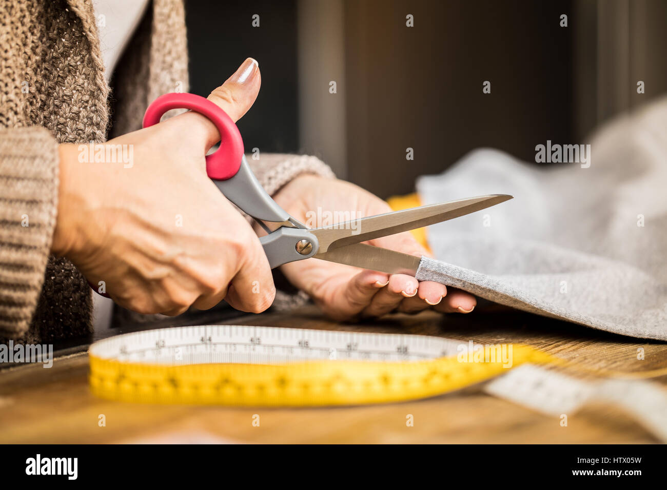 Woman cutting fabric Stock Photo - Alamy