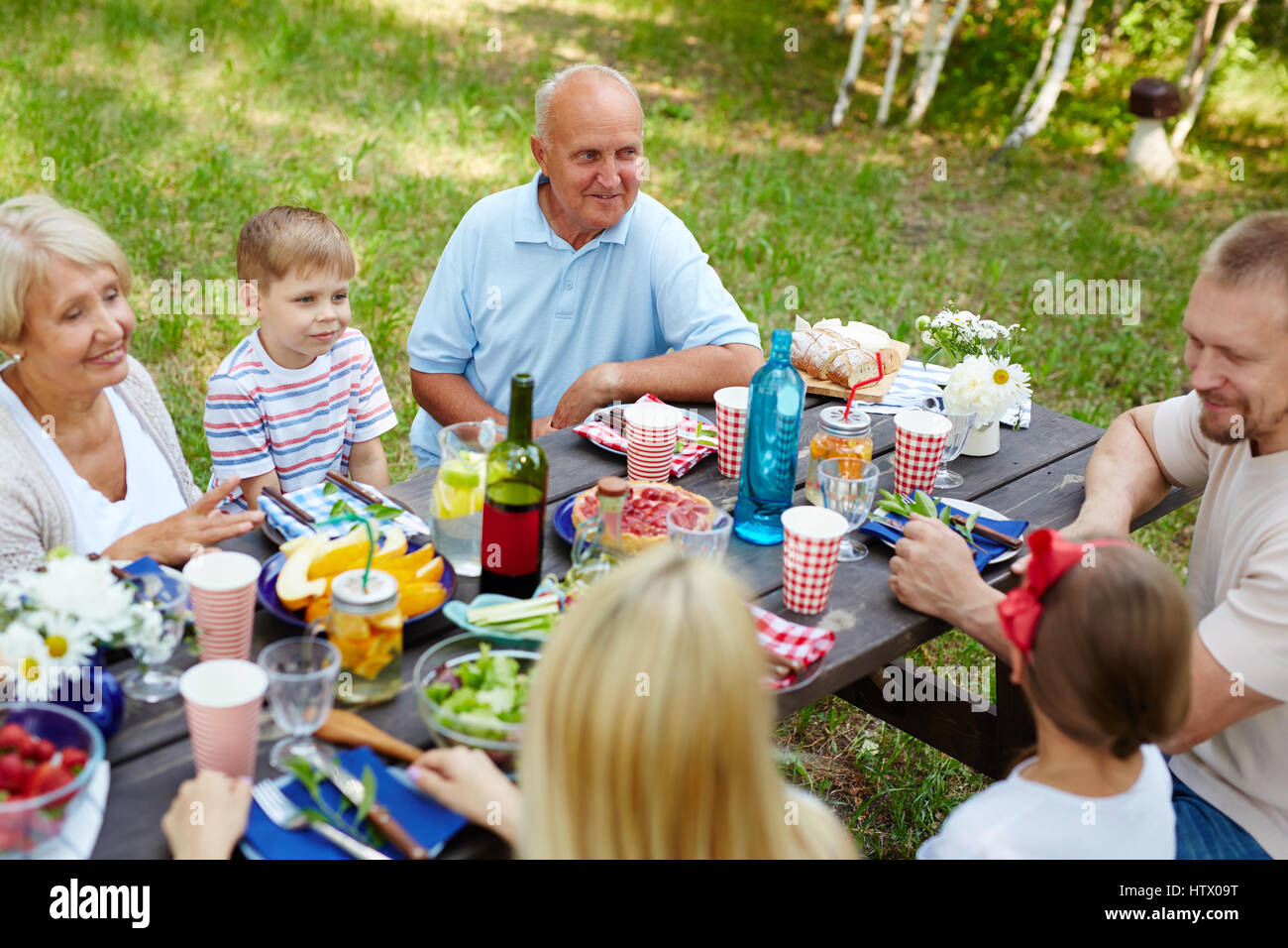 Big friendly family having outdoor dinner on summer day Stock Photo - Alamy