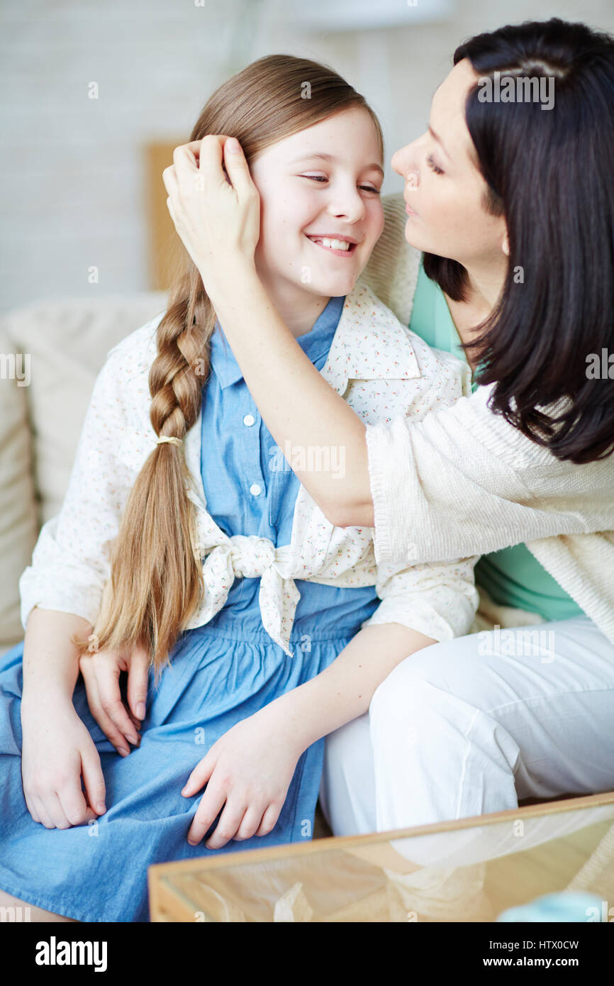 Happy child laughing while mother taking care of her Stock Photo - Alamy