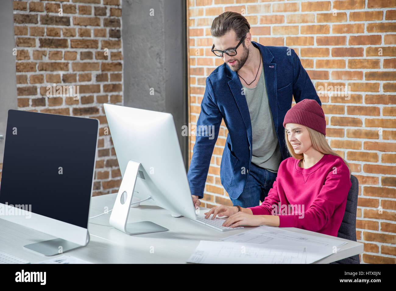 Man and woman working on computer Stock Photo - Alamy