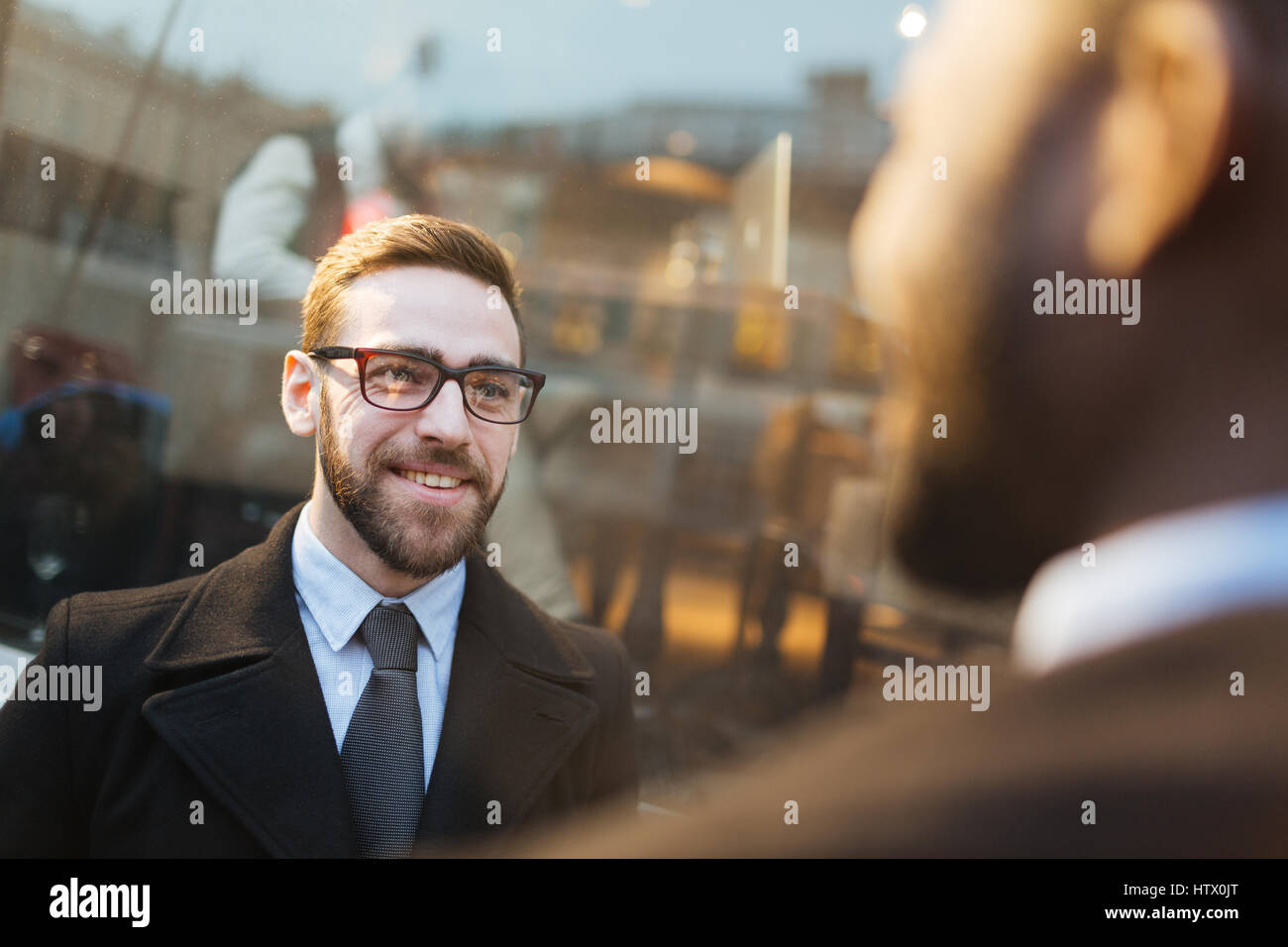 Smart agent talking to colleague or client outdoors Stock Photo - Alamy