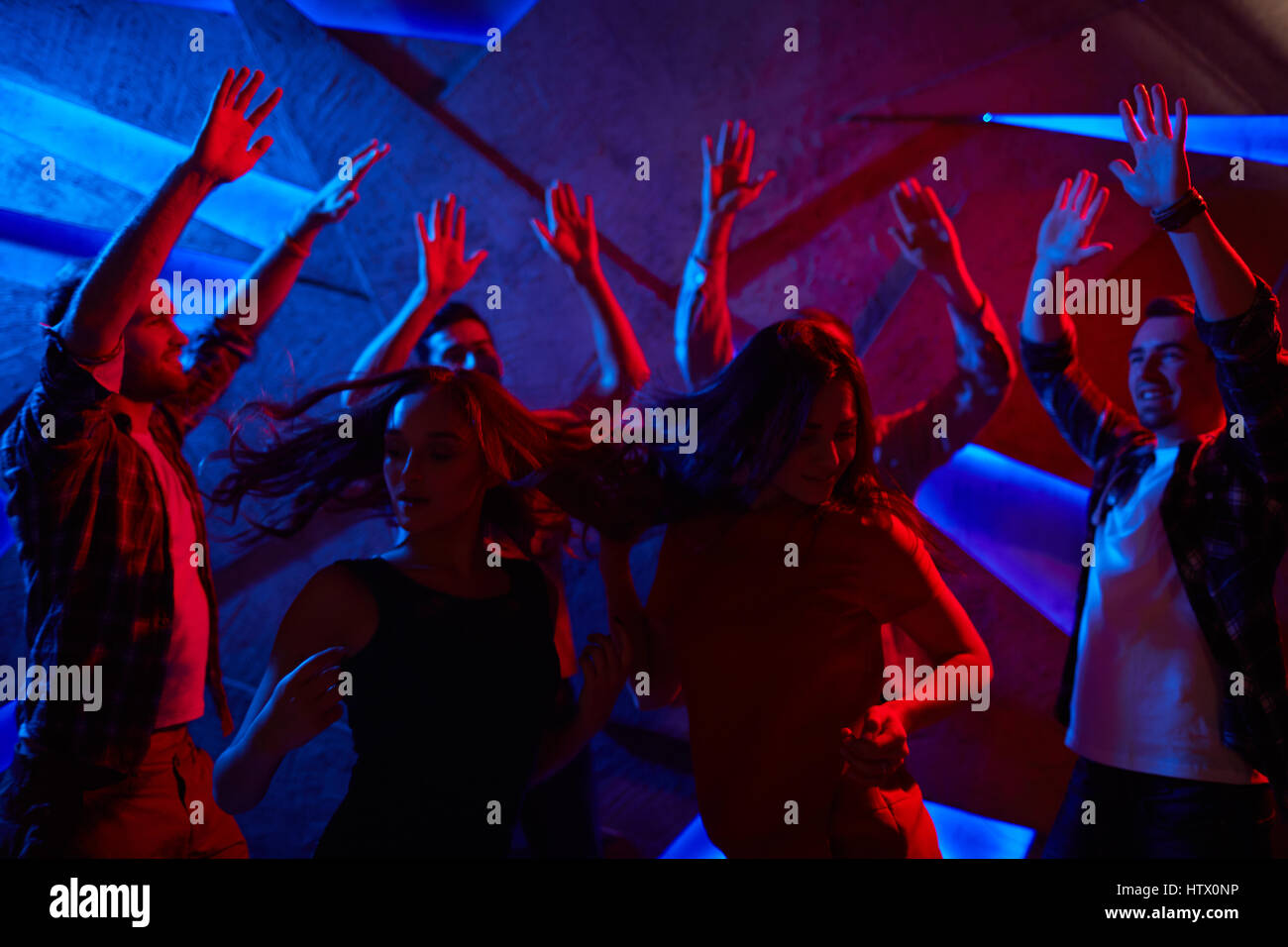 Group of raving dancers enjoying discotheque Stock Photo - Alamy