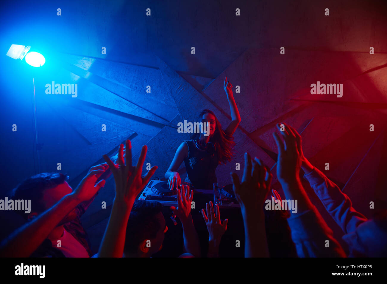 Cheerful girl entertaining ecstatic crowd of dancers Stock Photo - Alamy