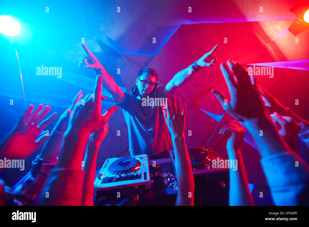 Deejay and crowd raving in disco club Stock Photo - Alamy