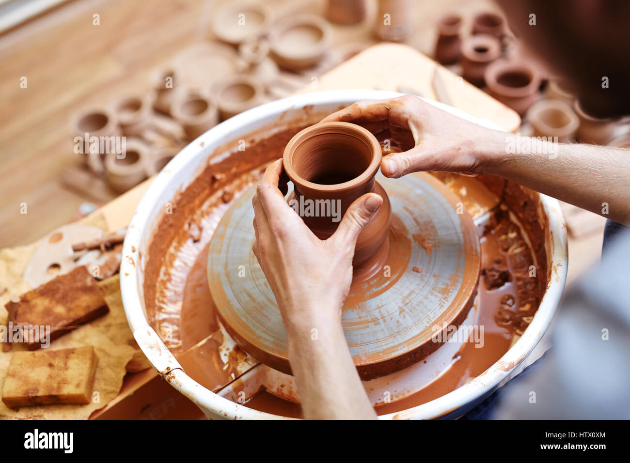 Young master making clay jug in pottery-wheel Stock Photo - Alamy