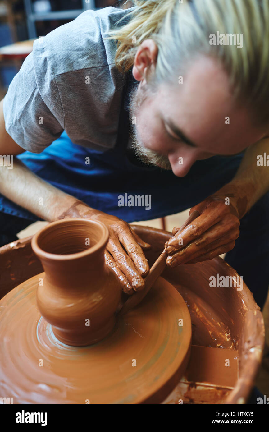 Craftsman finishing up with new jug in pottery wheel Stock Photo - Alamy