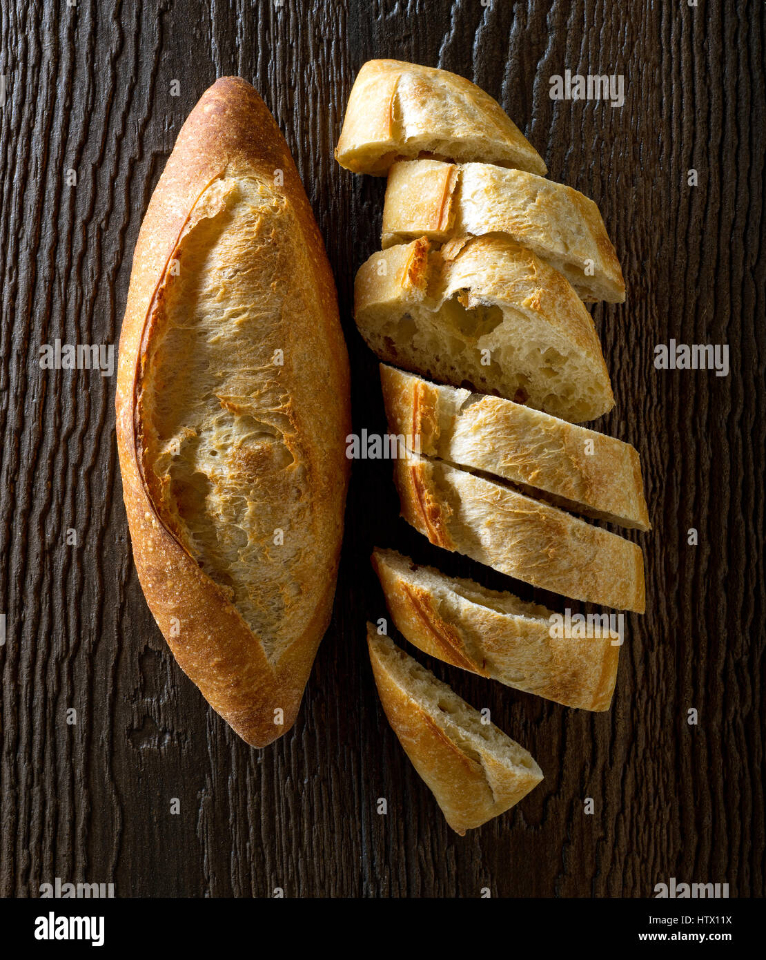 Freshly baked french bread baguettes on a rustic wood table Stock Photo ...