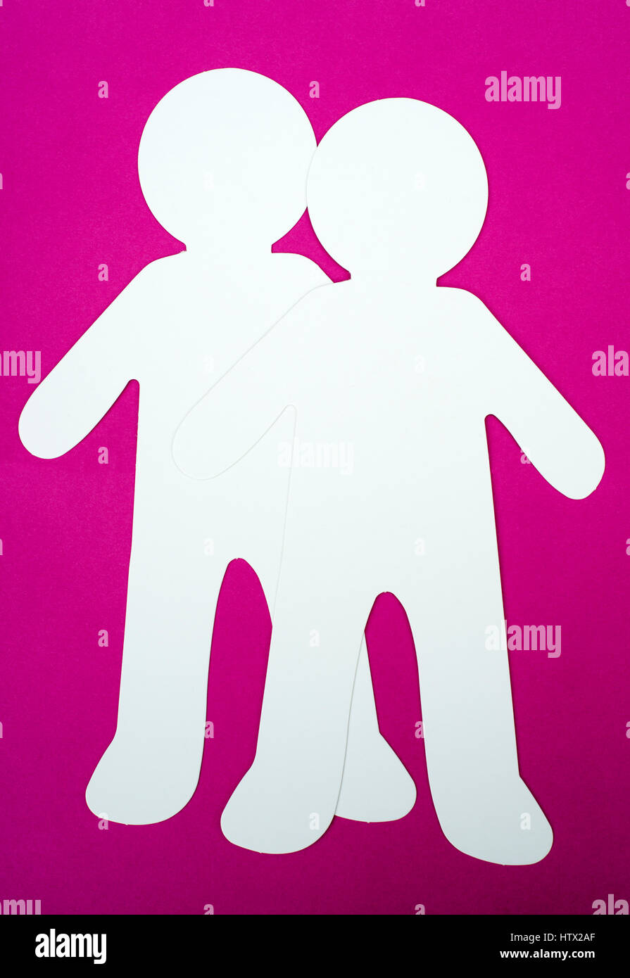 Paper cut-outs of two male figures on a pink background Stock Photo - Alamy