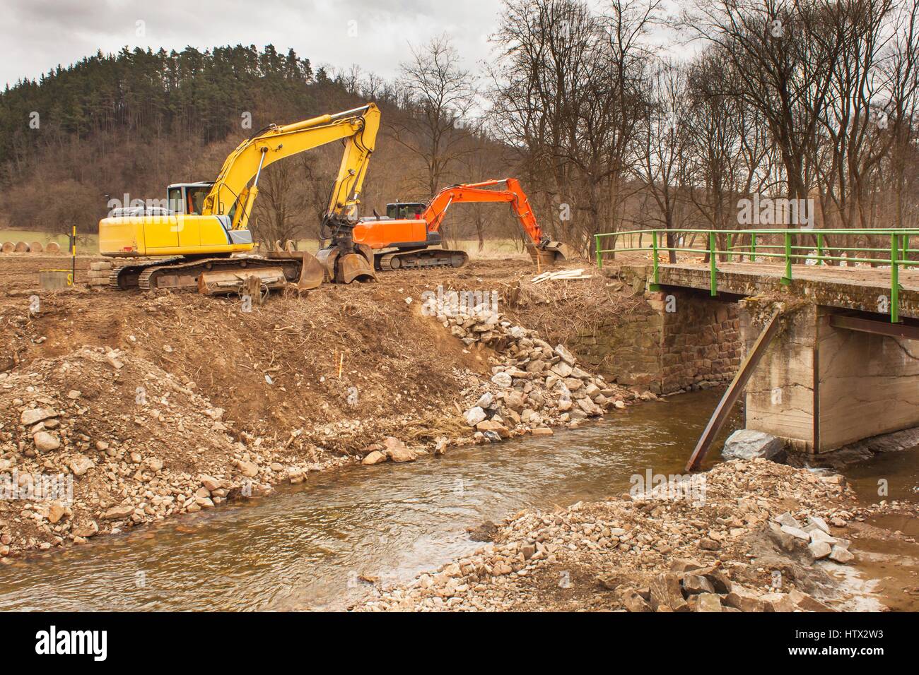 Flood adjustments river. Work on the riverbed. Excavator on the work to ...