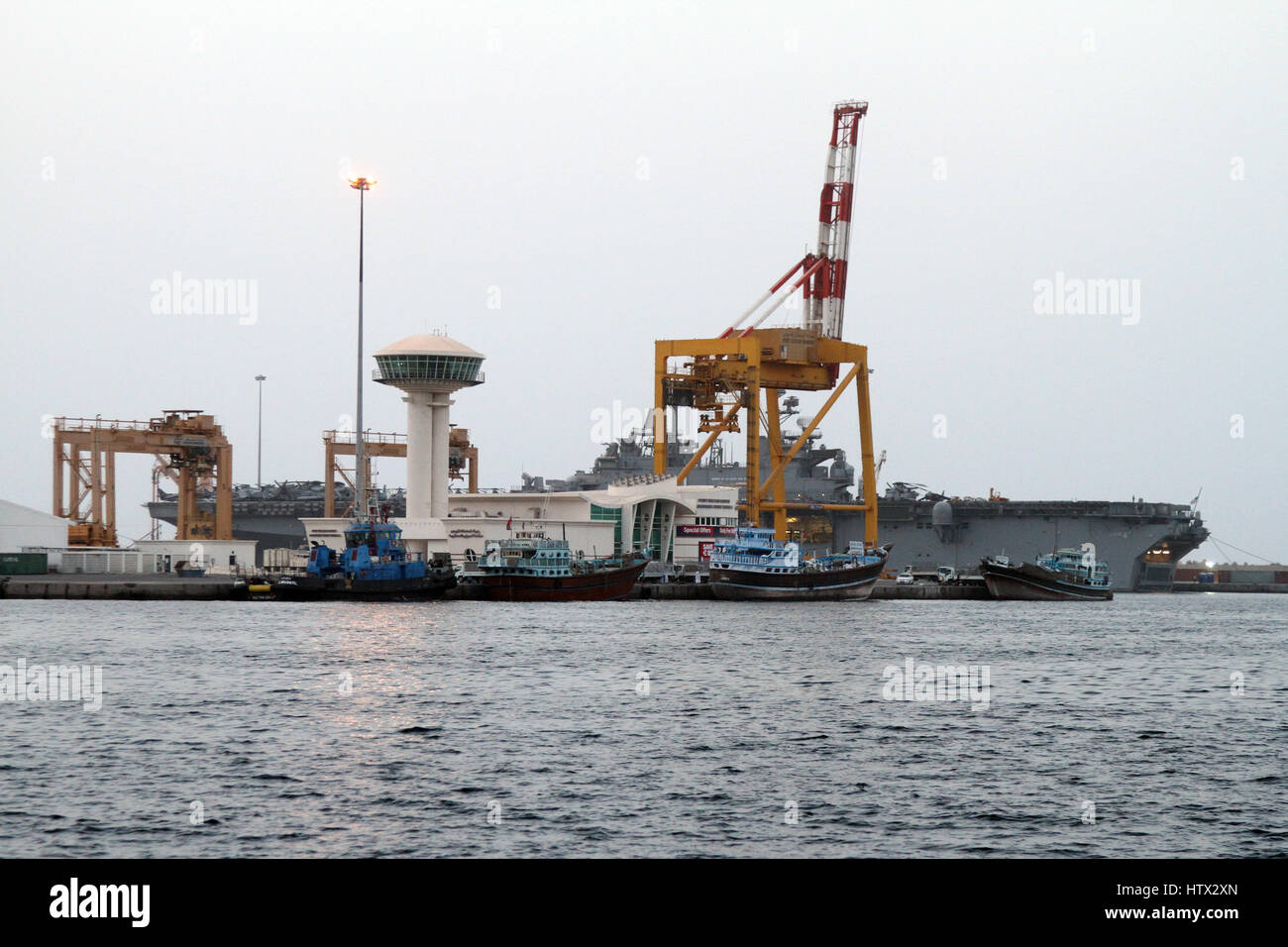 A US Navy aircraft carrier moored at Port Sultan Qaboos, Muscat, Oman ...