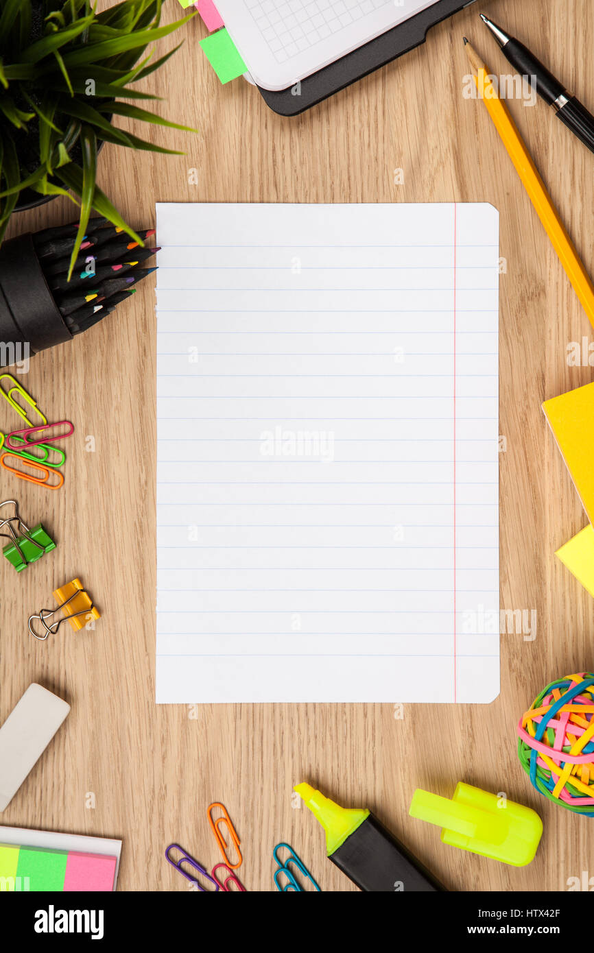 Open notepad with office supplies Stock Photo - Alamy