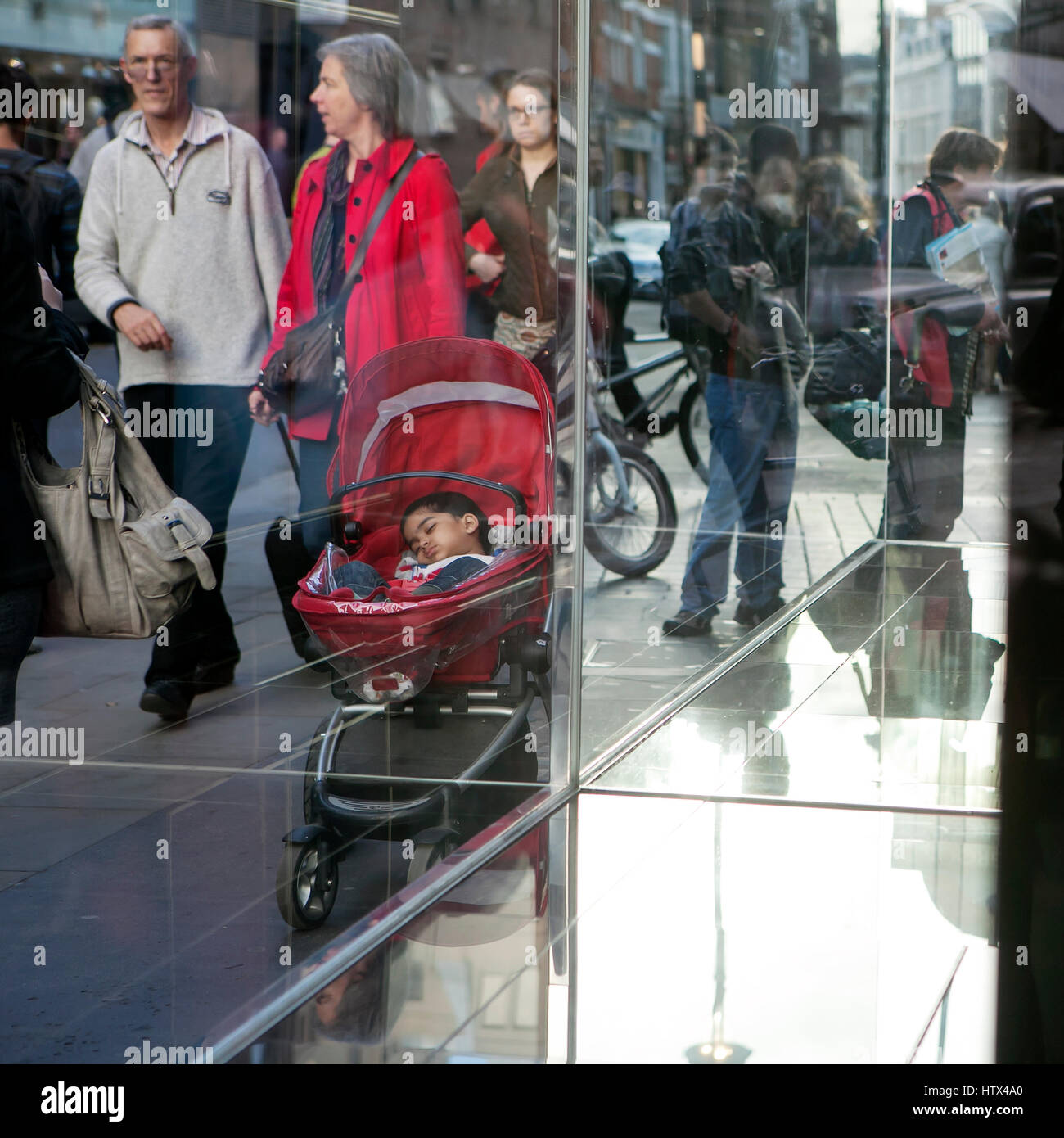 LONDON, ENGLAND - April 12, 2016 Reflection in the window. A woman is ...